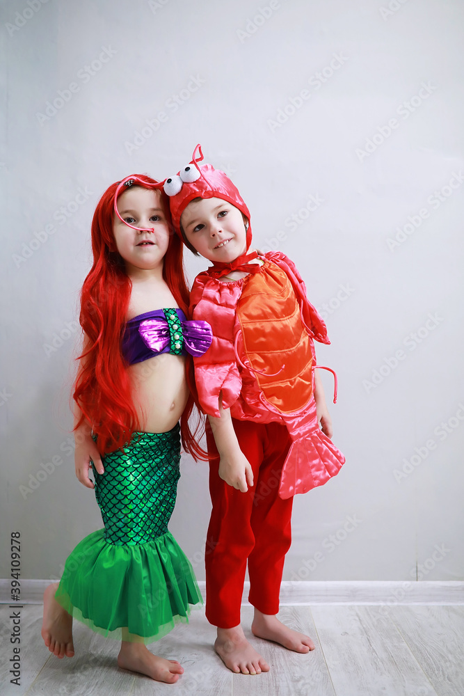 Children in smart carnival costumes on a plain background. Costume of ...
