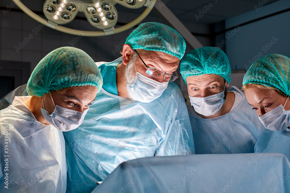 operating room caucasian team of professional surgeons and nurses ...