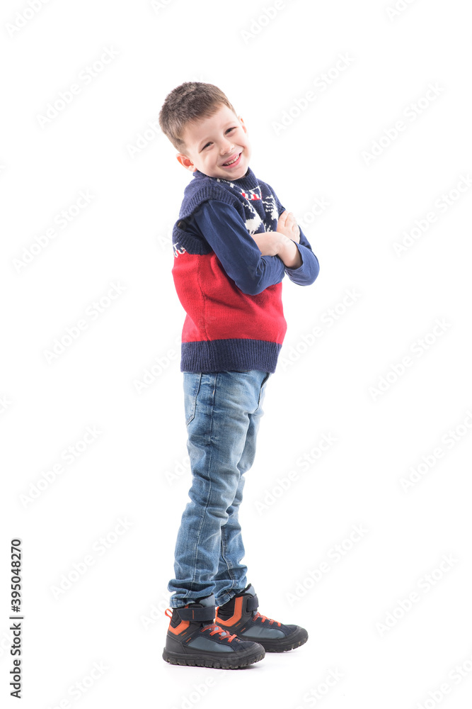 Side view of happy cute young boy with crossed hands smiling and ...