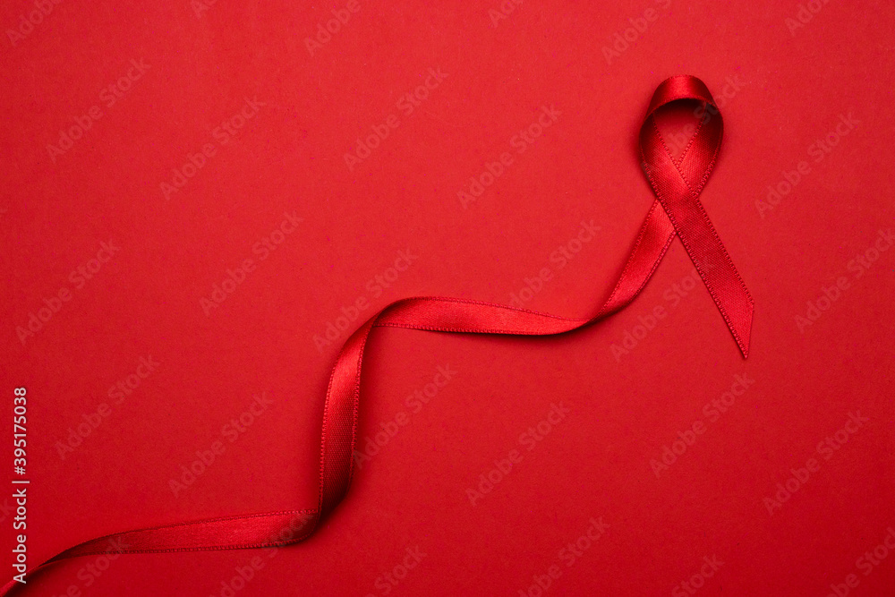 Hiv day. Red ribbon symbol in hiv world day on dark red background. Awareness aids and cancer ...