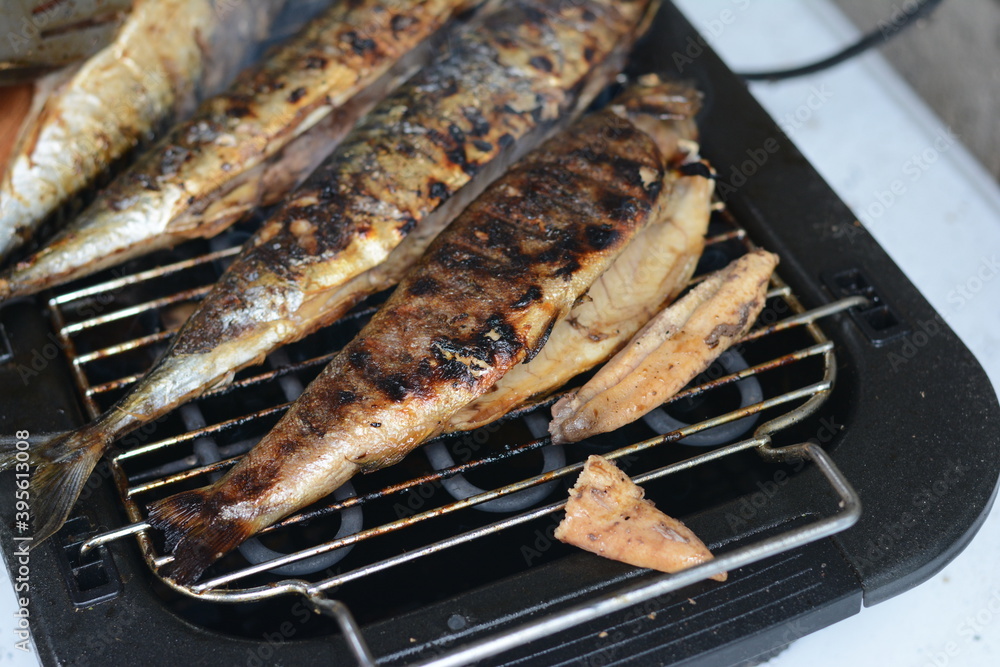 Barbecue with fish. Grilled mackerel fish. Fatty, oily fish is an ...