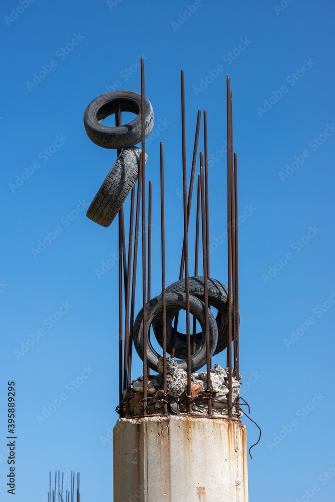 An unfinished and abandoned round reinforced concrete column with ...