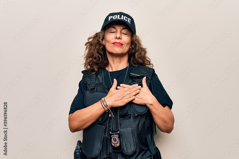 Middle age beautiful policewoman wearing bulletproof uniform and cap ...