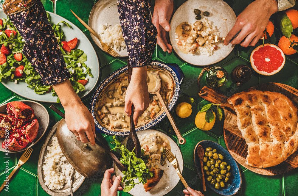 Family having Turkish dinner. Flat-lay of people hands taking lamb in ...