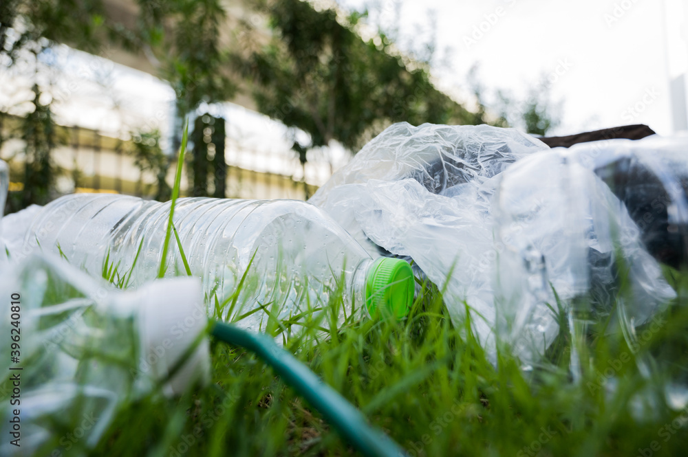 Plastic bottles and plastic bags and straws stacked together in the ...