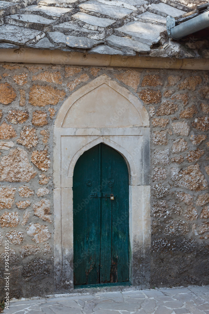 Historic wooden door in a Koski Mehmed Pasha Mosque in Mostar. Bosnia ...