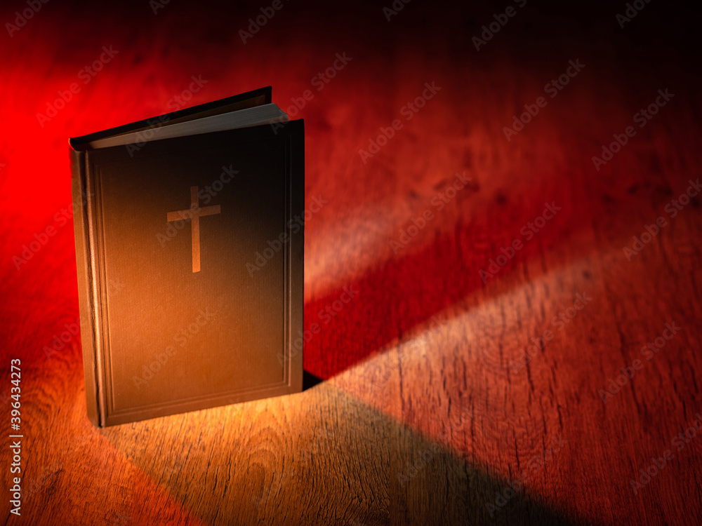 Catholicism, Protestantism and Orthodoxy. The light falls on the Bible ...