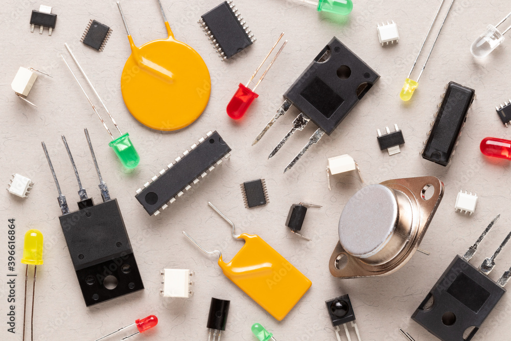 Electronic components on a beige background. There are microcontrollers ...