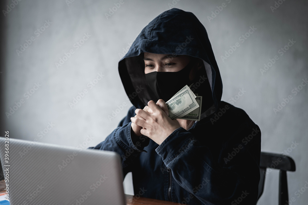 Dangerous Hooded Hacker held the money after successfully hacking ...