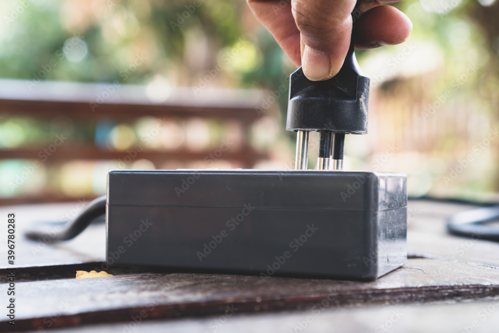 Hands putting socket electricity plug to connect electric multi-socket ...