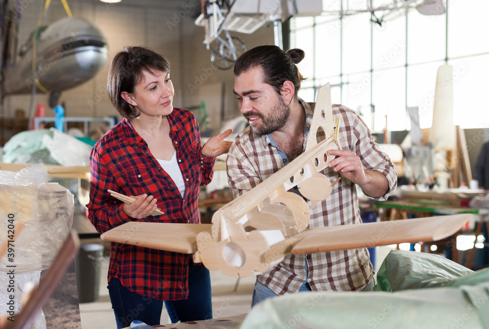 Positive couple enjoying their hobbies - modeling light airplanes in ...