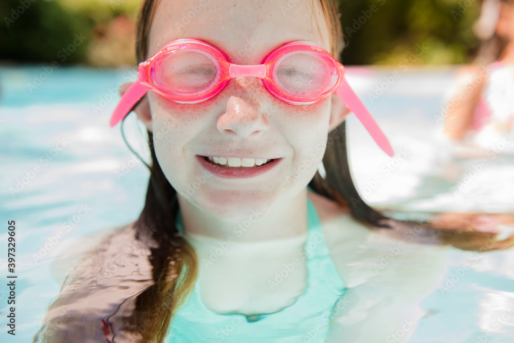 Caucasian girl in swimming pool wearing goggles Stock Photo | Adobe Stock