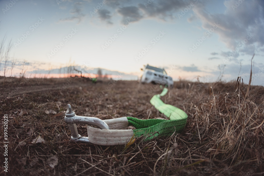 Towing hook with a rope on the stuck car in the swamp background. Stock ...