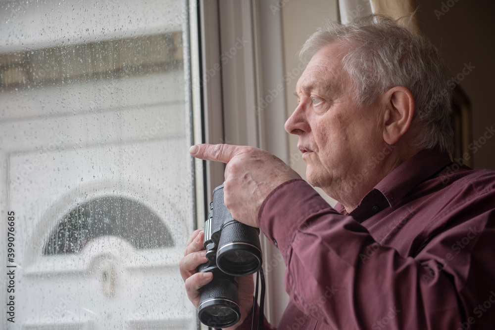 Nosy neighbor looking through window with binoculars Stock Photo ...