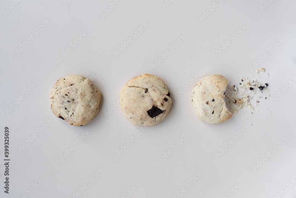 chocolate chip cookies standing next to each other on white background ...
