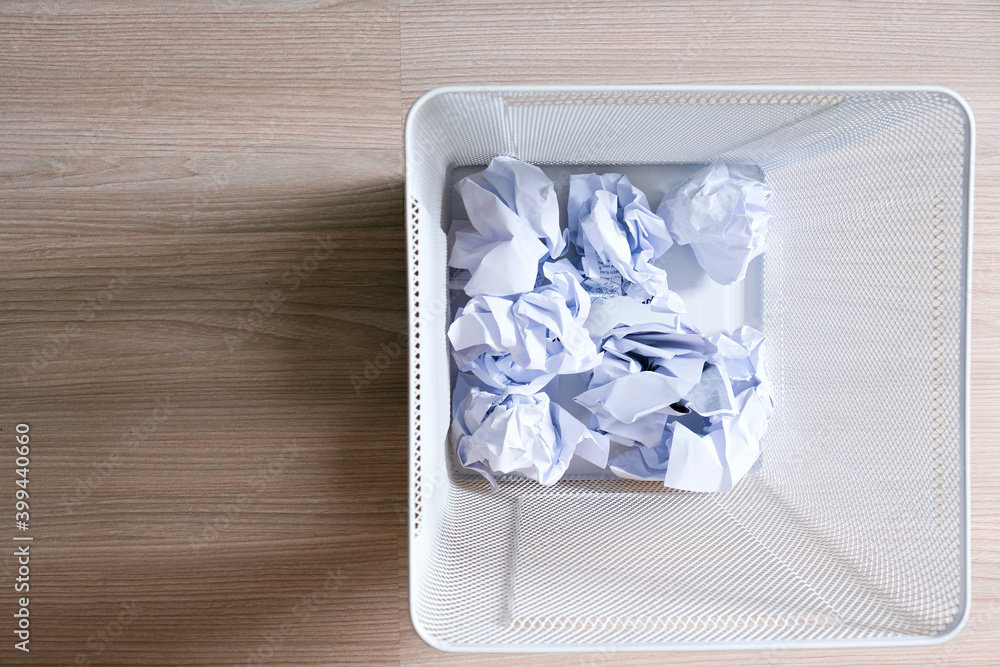 Throwing many crumpled paper ball into black garbage at the office. Its ...