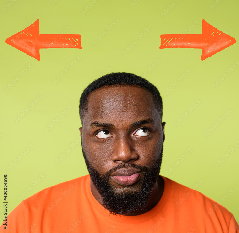 Confused black Man has to choose the right arrow to follow. Concept of ...