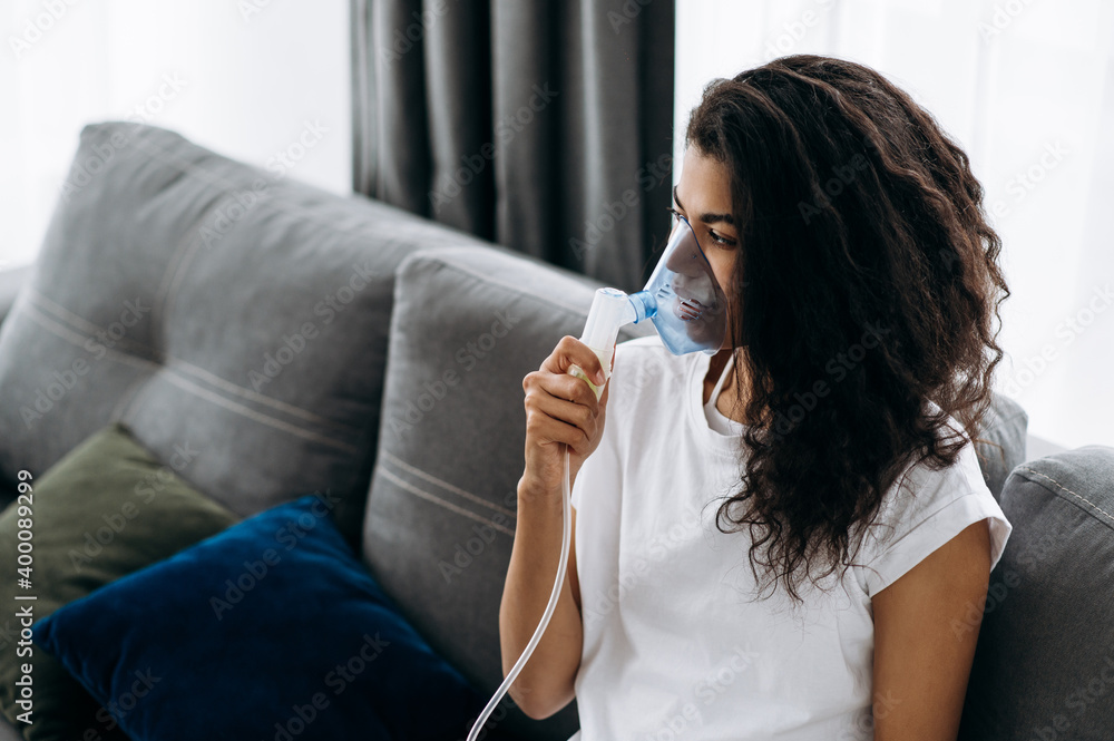 Close-up photo of sick african american woman with an inhaler ...