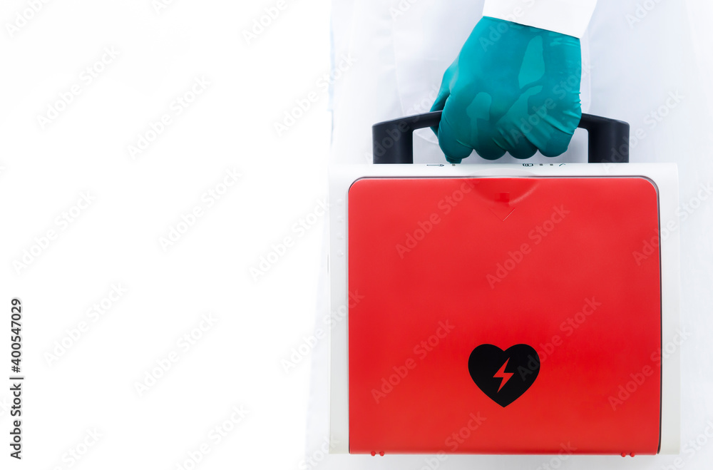 Aed rescue equipment Or a red heart defibrillator In the doctor's hand ...