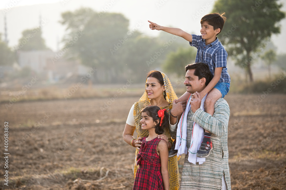 Happy rural Indian family on agricultural field Stock Photo | Adobe Stock