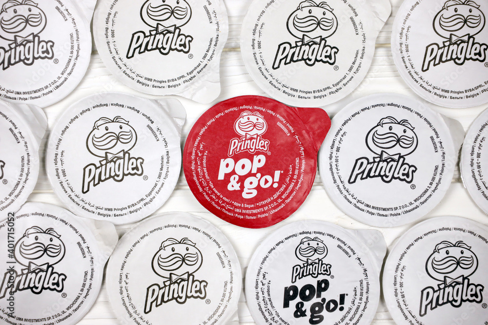 Pringles logo on paper membranes on white wooden table. Pringles is a ...