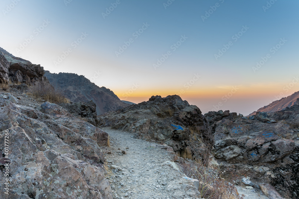 Barren mountain in Darband valley in dawn against colorful sky in the ...