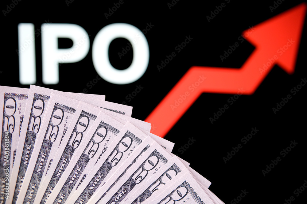 US dollar bills and IPO letters with red arrow on the blurred ...