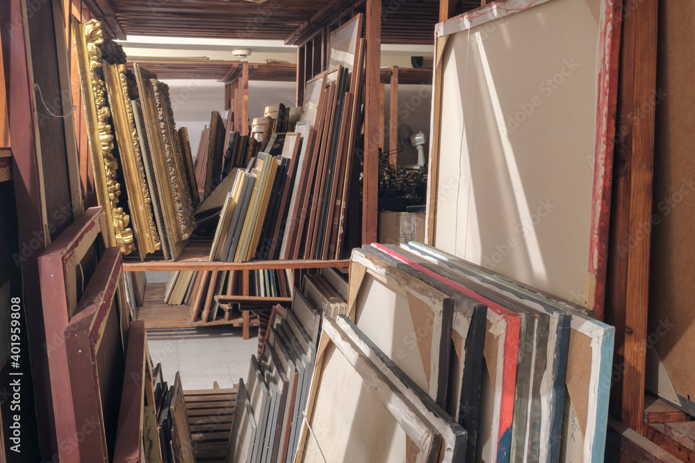 Wooden shelves at art gallery storage full of pictures and art ...