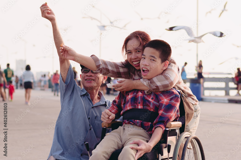 Asian Disabled child on wheelchair and parents the outdoors nature and ...
