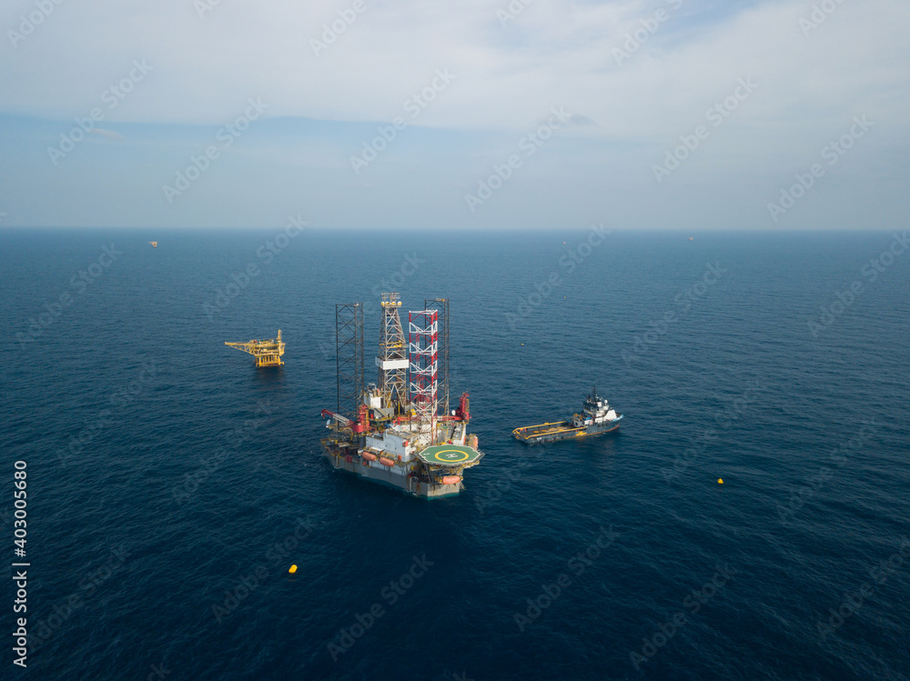 Offshore jack up rig and tow vessels during the rig move operation at ...