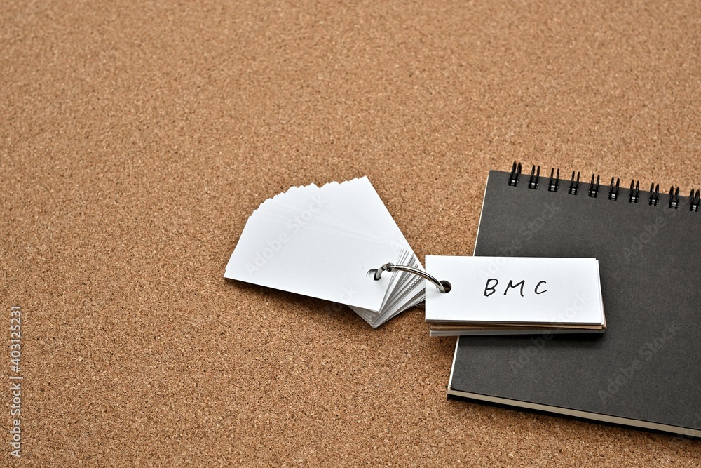 On top of the notebook on the cork board is a wordbook with the word ...