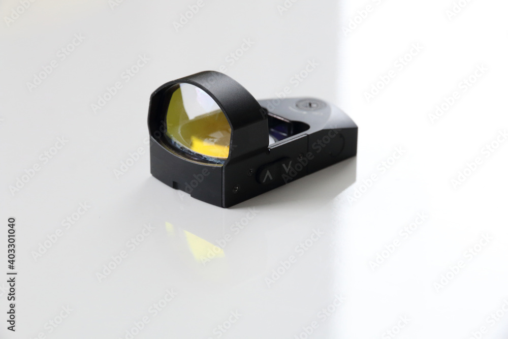 Closeup of a red dot sight for pistol or rifle on a white background ...