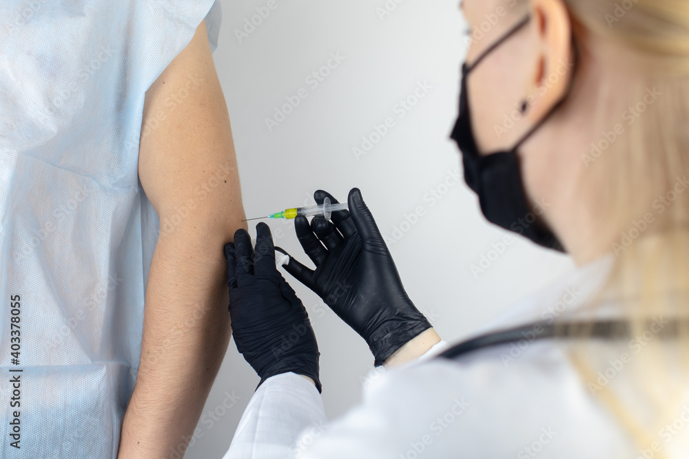 An orthopedic surgeon gives an injection in the elbow. Treatment of ...