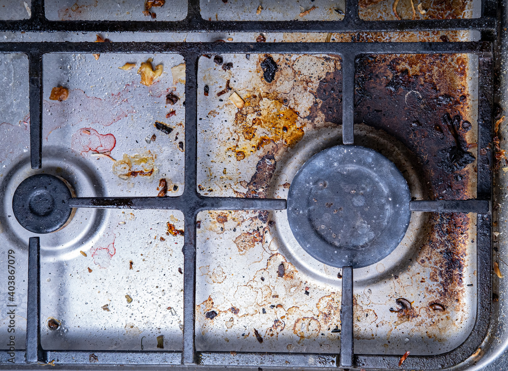 unclean gas stove, steel kitchen cooktop, old fat stains, fry spots ...