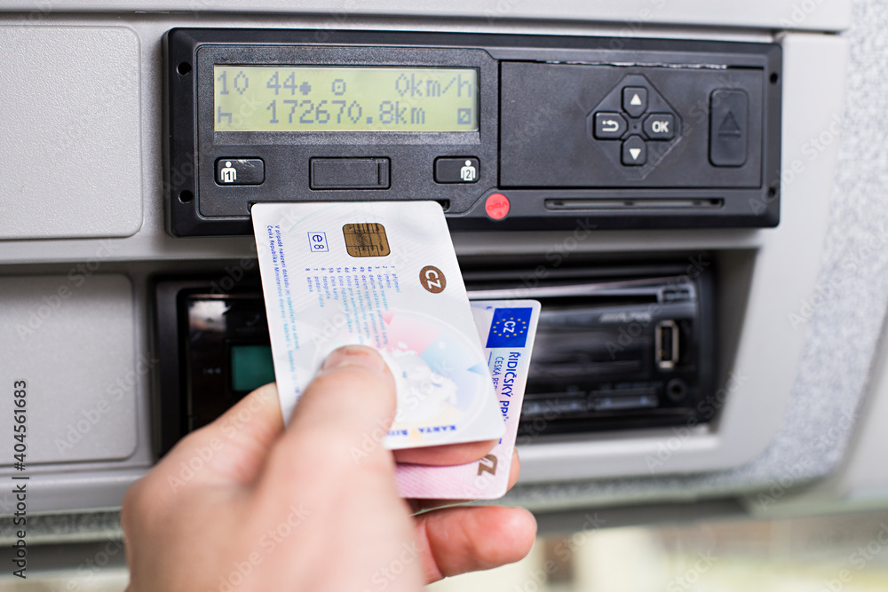 Hand holding a driver digital card and Europian driving licence infront ...