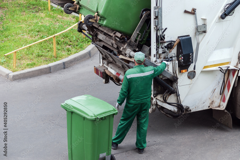garbage collector loads garbage truck with household waste from garbage ...