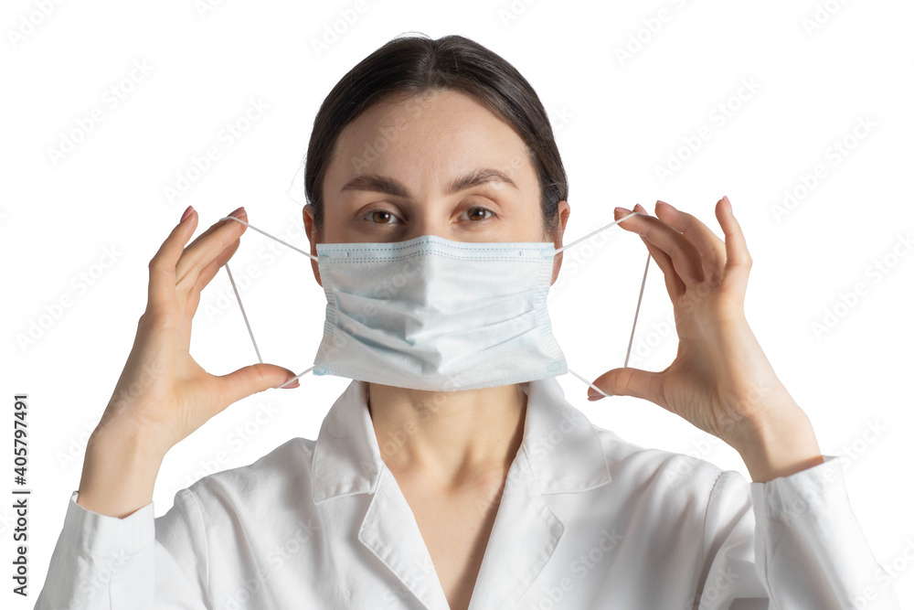 Cute female doctor, nurse puts on a medical face mask, respirator ...