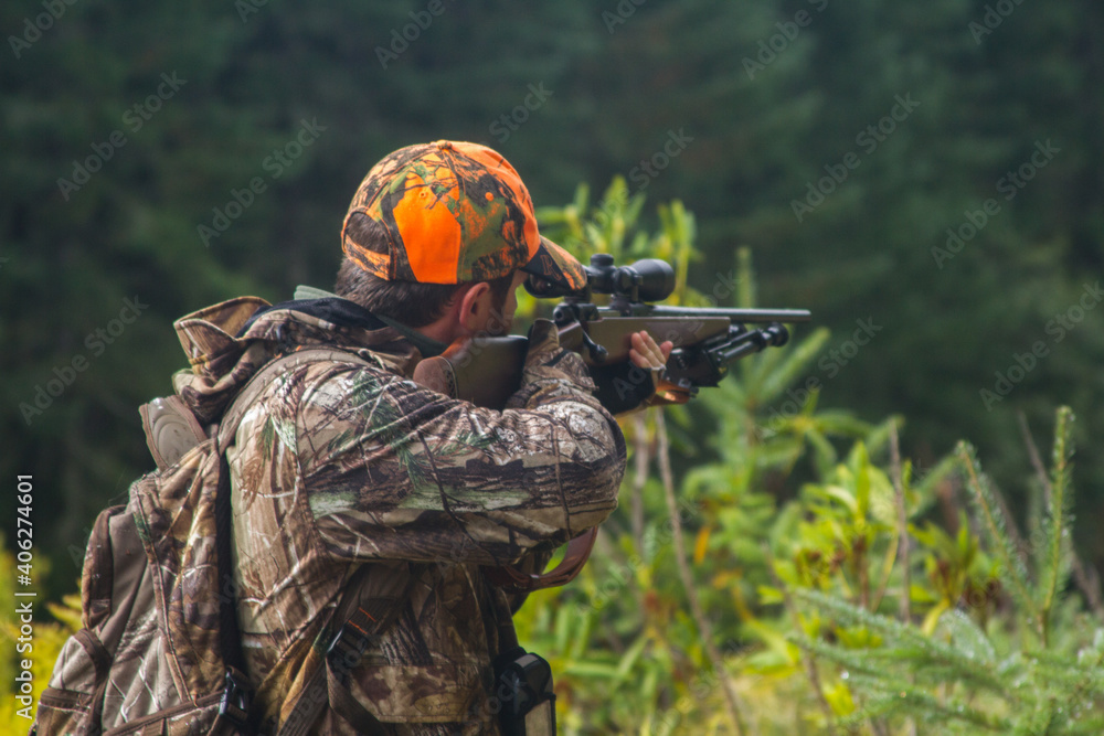 Young hunter aiming rifle in the forest Stock Photo | Adobe Stock