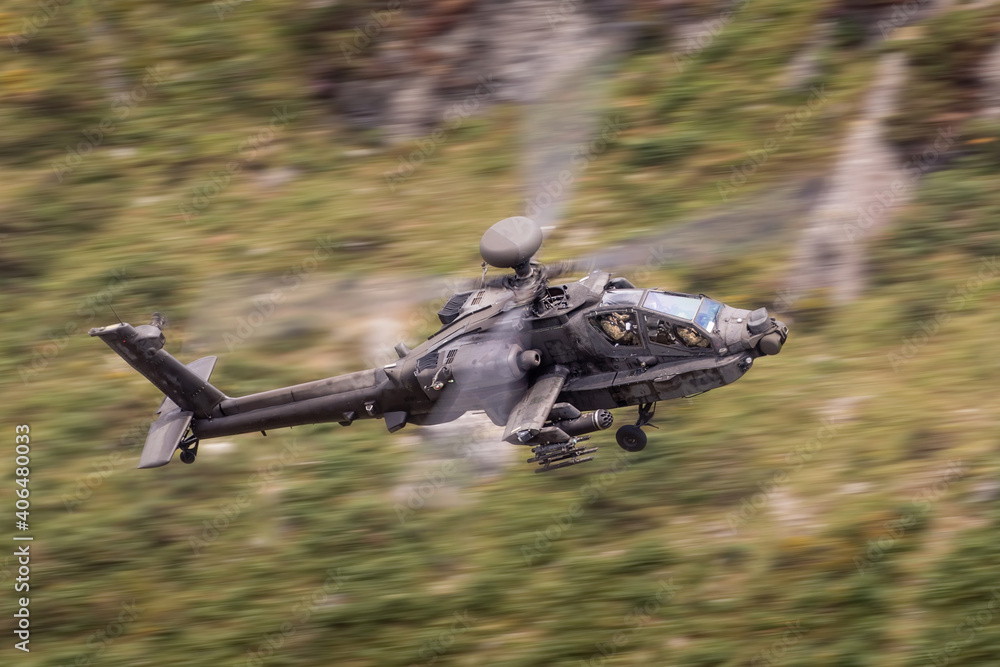 Low Flying AH-64 Apache attack helicopter against a green background as ...