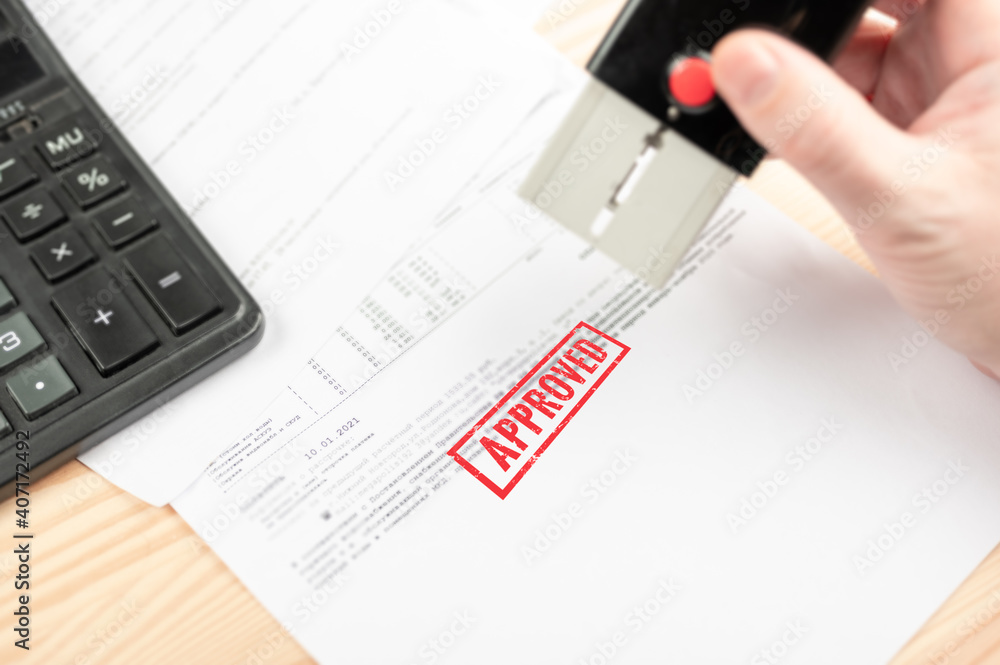 approved stamp. tender acceptance - hand put a approved stamp on ...