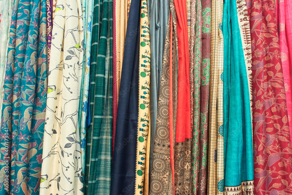 Assorted colourful Indian saris, showcased for retail display ...