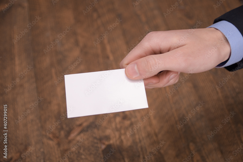 Hand hold blank white card mockup with rounded corners. Plain call-card ...