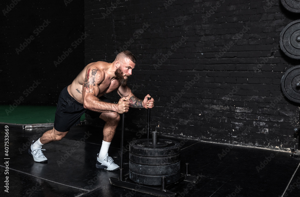 Young strong active sweaty muscular fit man with big muscles pushing ...