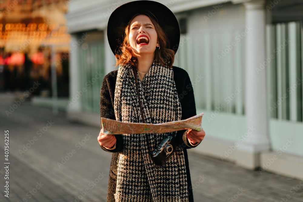 Crying woman in hat standing on the street. Upset female tourist ...