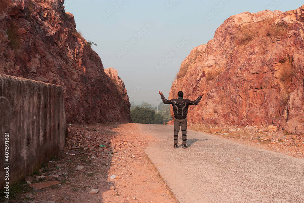 motorcycle rider standing on tarmac road isolated Stock Photo | Adobe Stock
