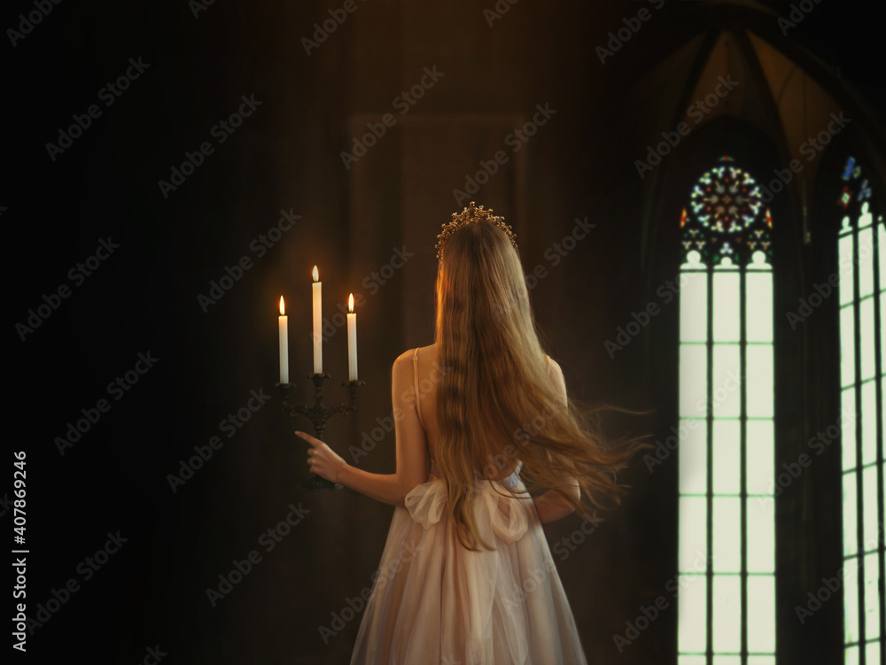 Mysterious art medieval girl princess walks in dark gothic room. Woman queen is holding ...