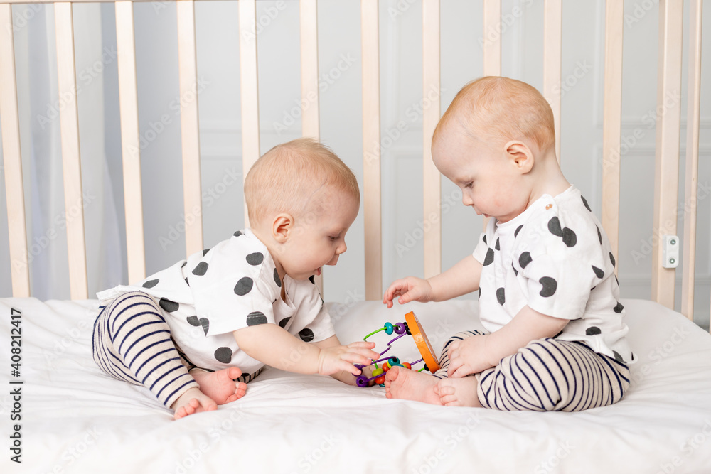 two twin babies play in the crib, the concept of the relationship of ...