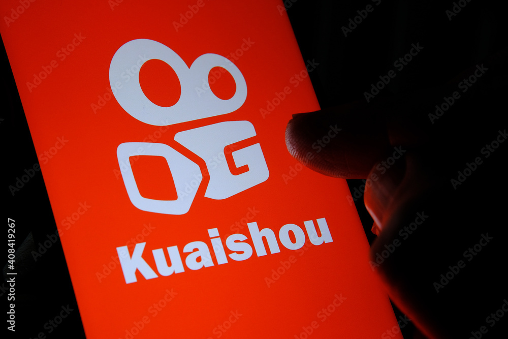 Kuaishou app logo seen on the smartphone screen and blurred finger ...