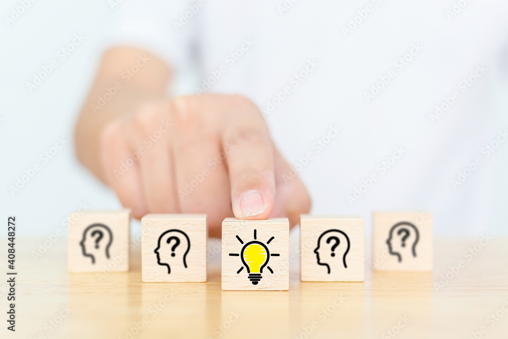 Photo Stock Concept creative idea and innovation. Hand choose wooden cube block with head human ...