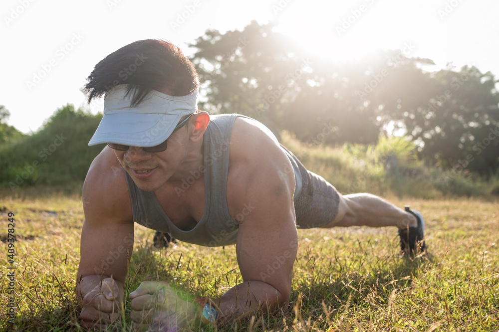 Closeup of a fit Filipino male doing planks as part of his abdominal ...
